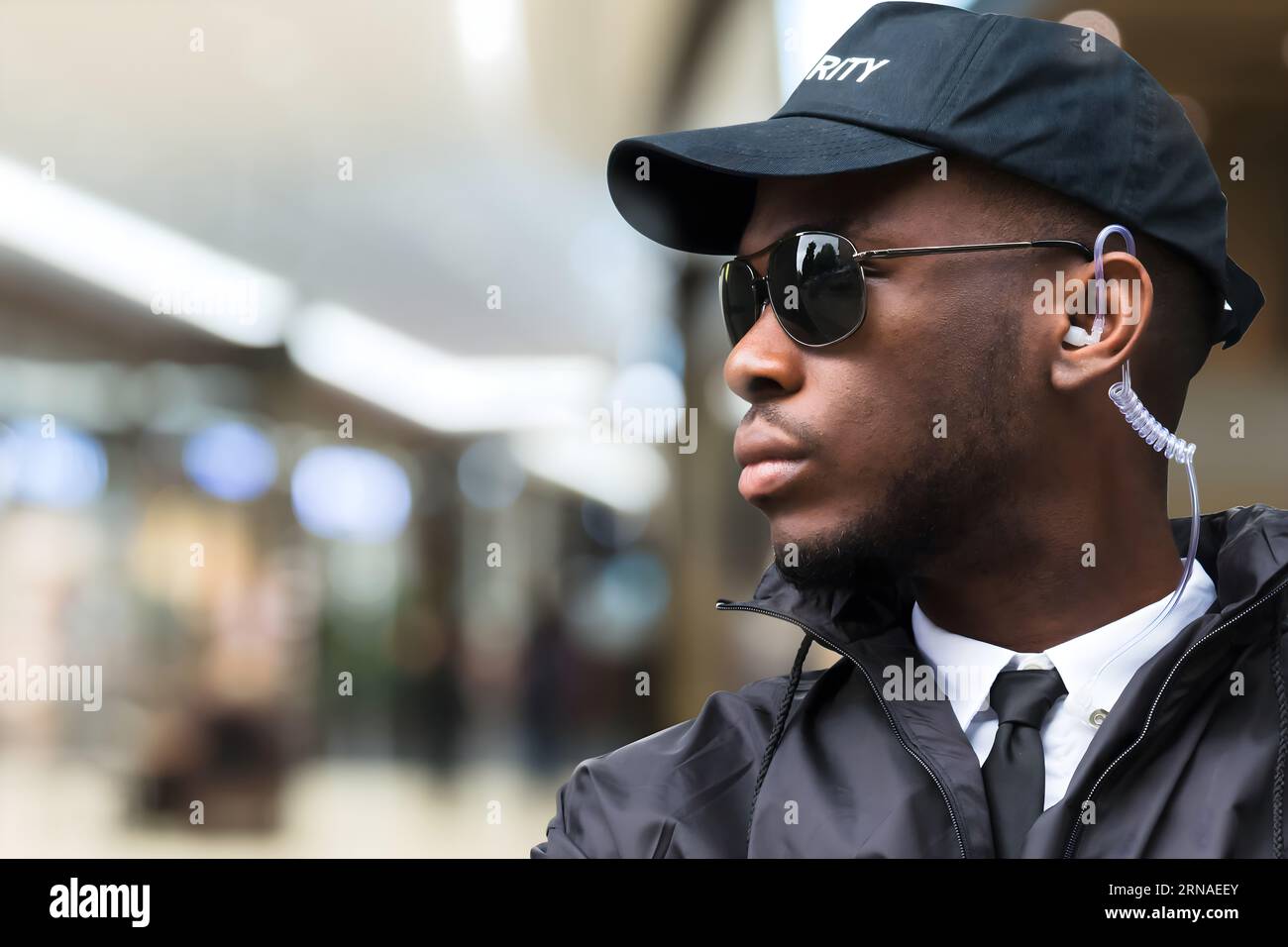 Security Guard Officer Standing In Shopping Mall Stock Photo - Alamy