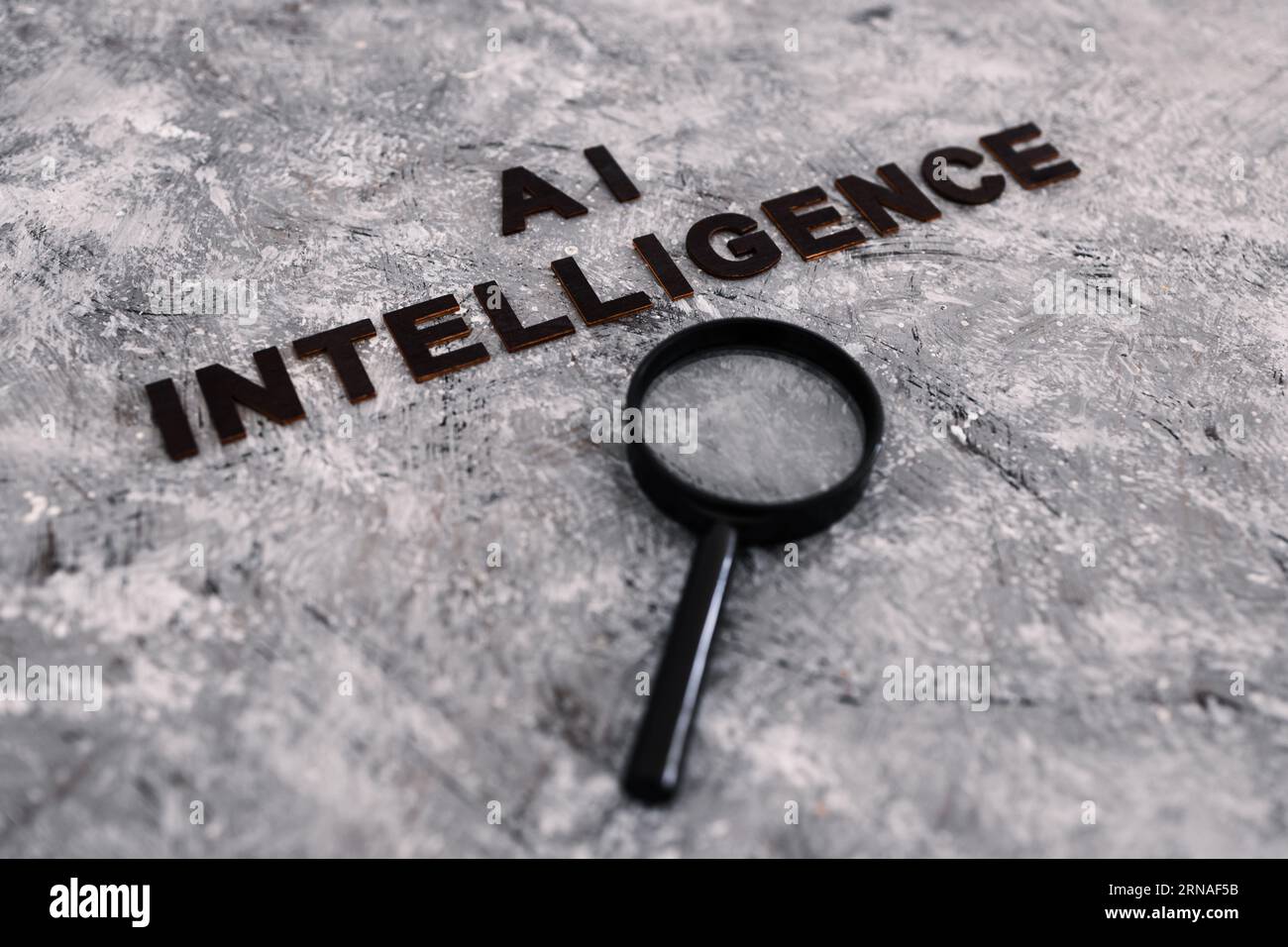 AI intelligence text with magnifying glass analysing it, concept of ...