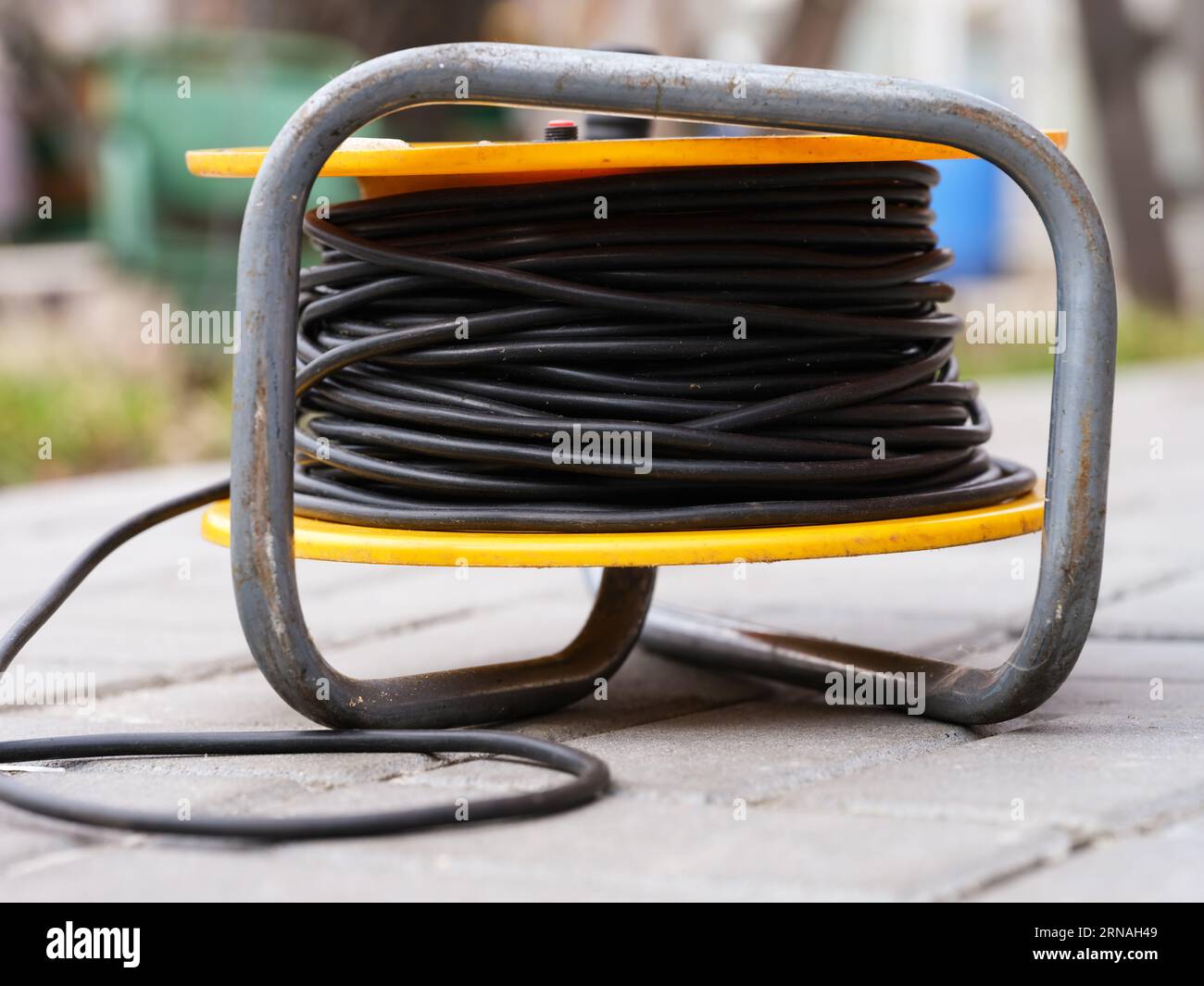 A cable extender wrapped around a yellow reel Stock Photo - Alamy