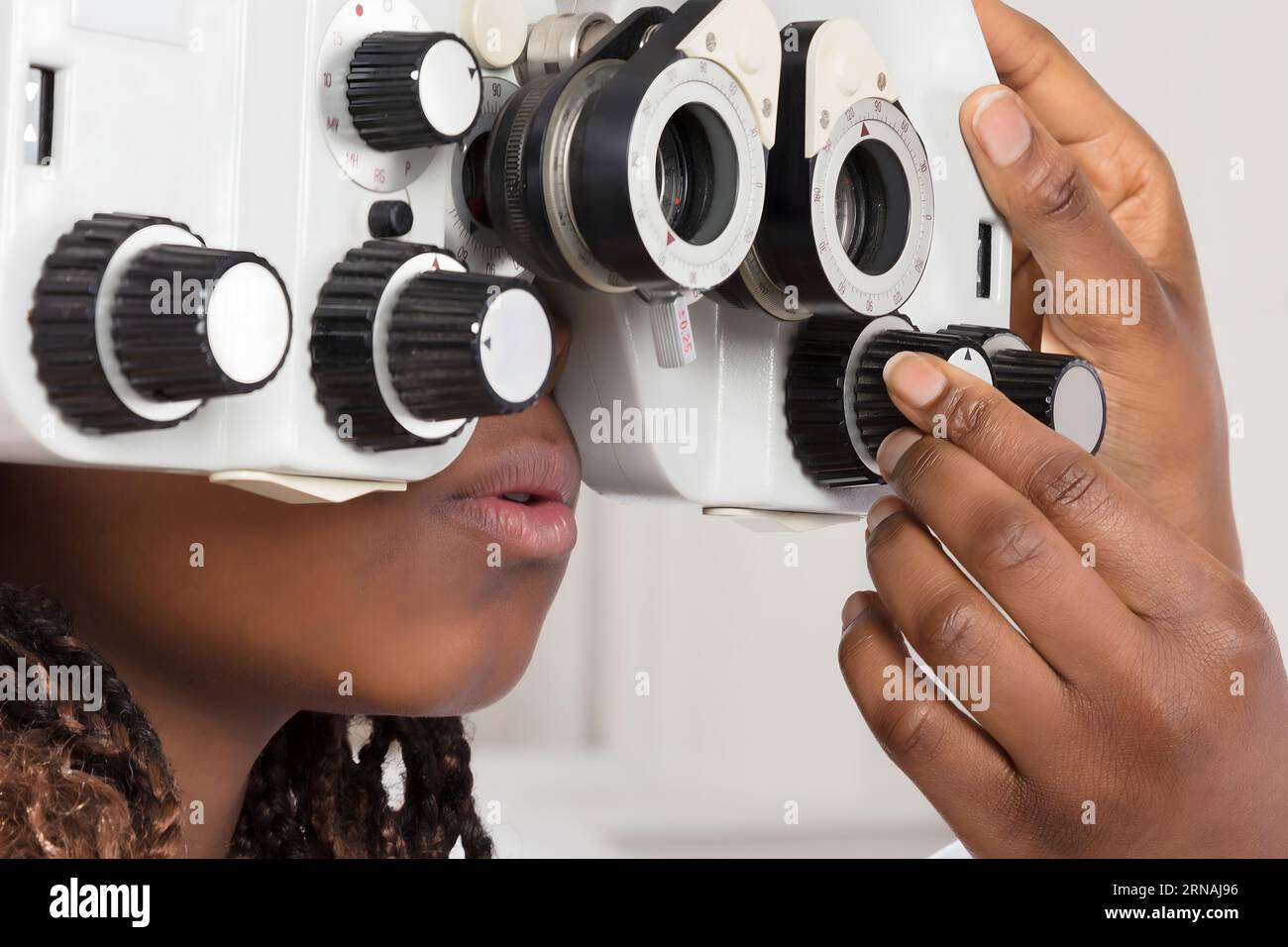Female African Optometrist Doing Sight Testing For Patient In Hospital ...