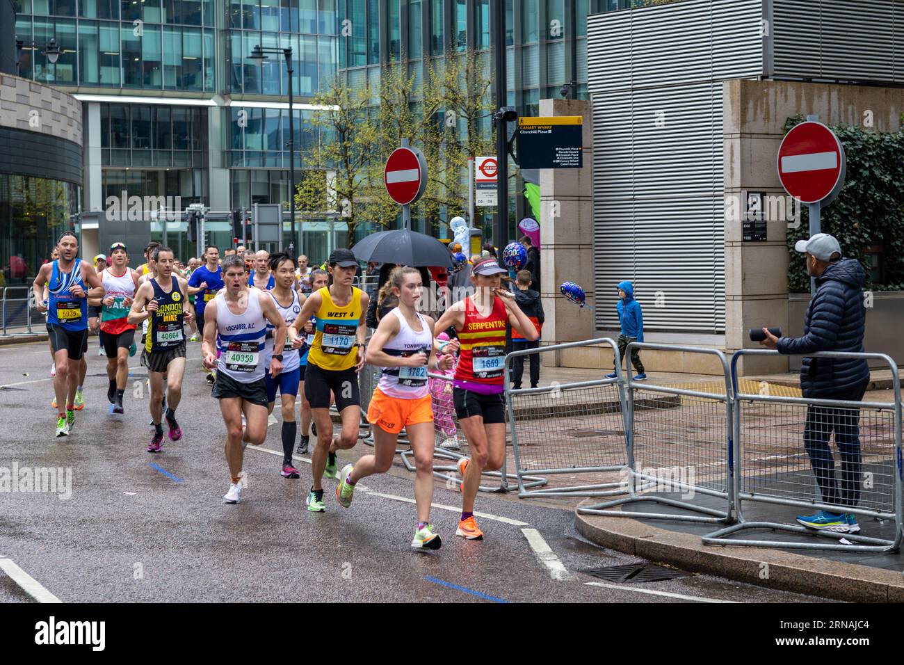 A group of people running at London Marathon at Canary Wharf in London ...