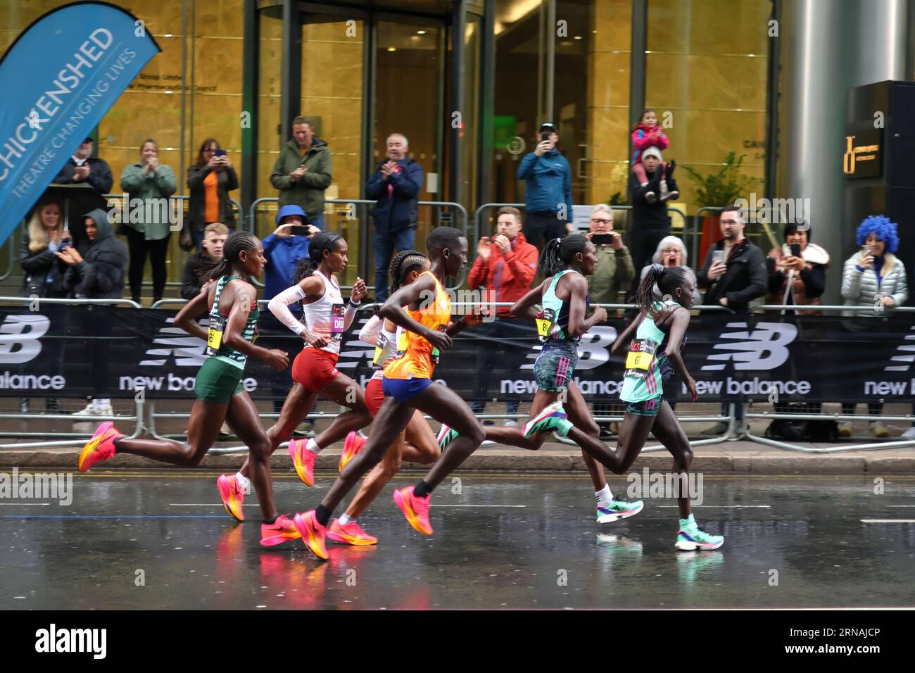 A group of people running at London Marathon at Canary Wharf in London ...