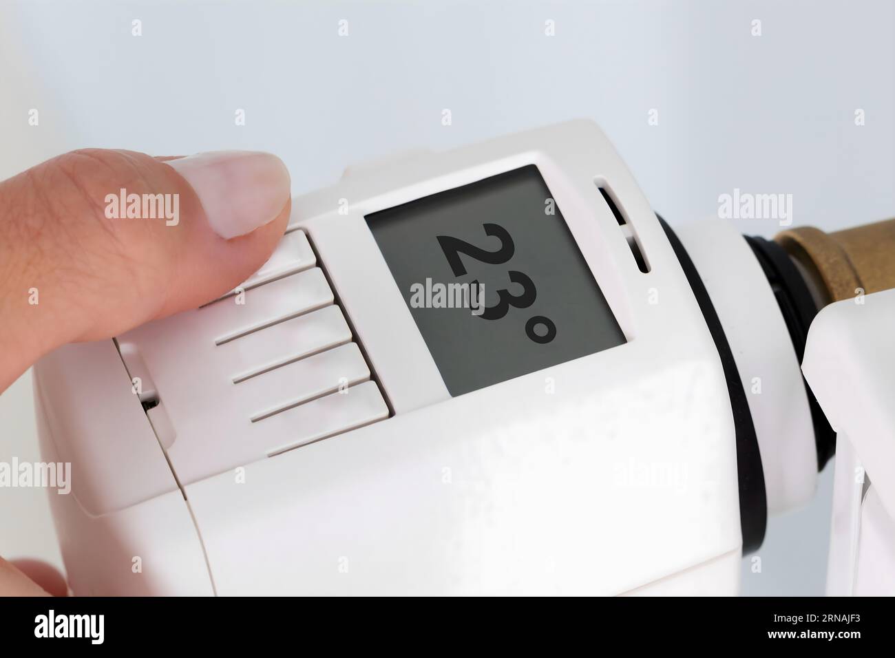 Person's Hand Adjusting Temperature On Thermostat To Control Heat In ...