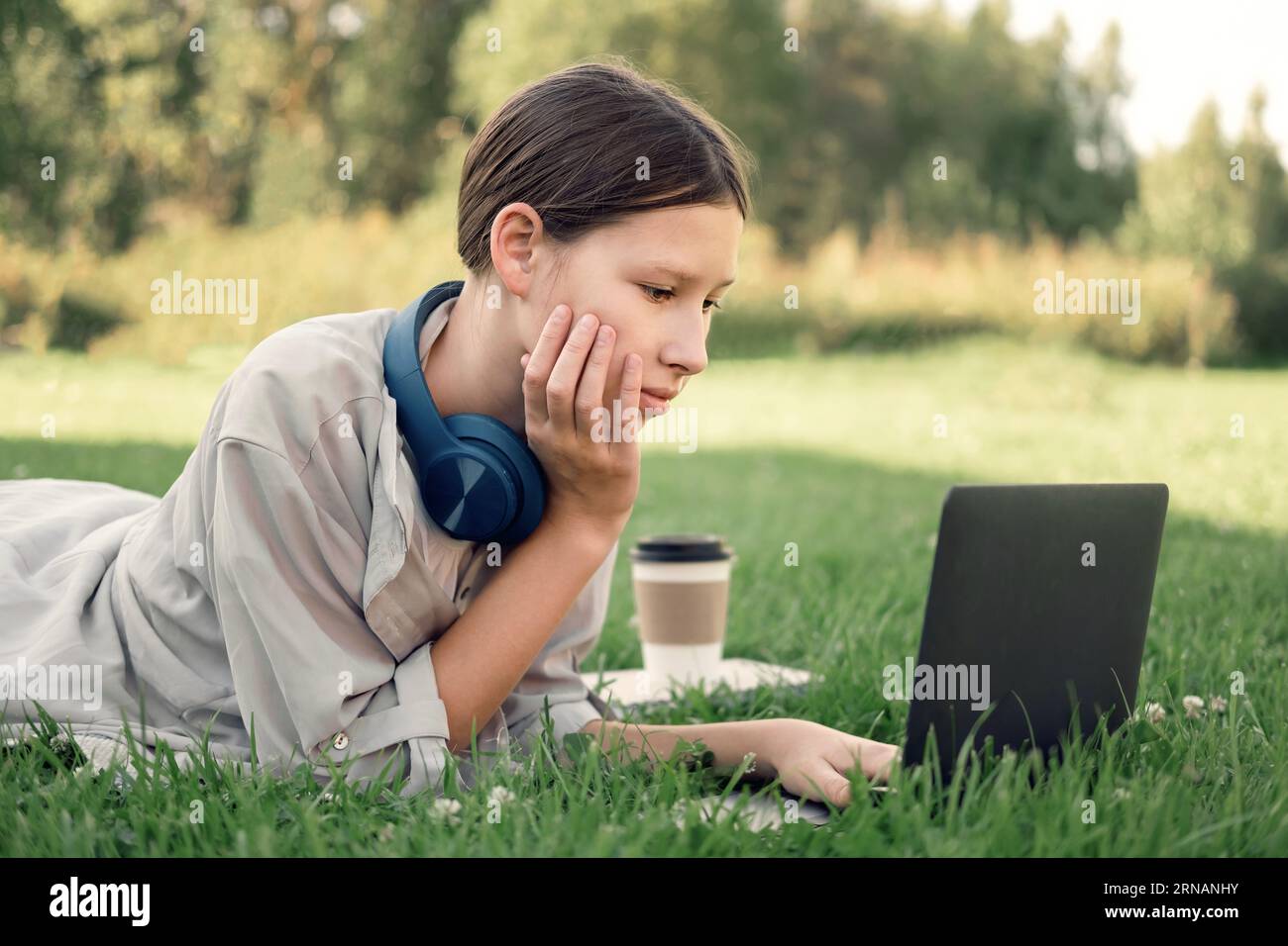 Teenage schoolgirl studying reading her books, tablet and notebook ...