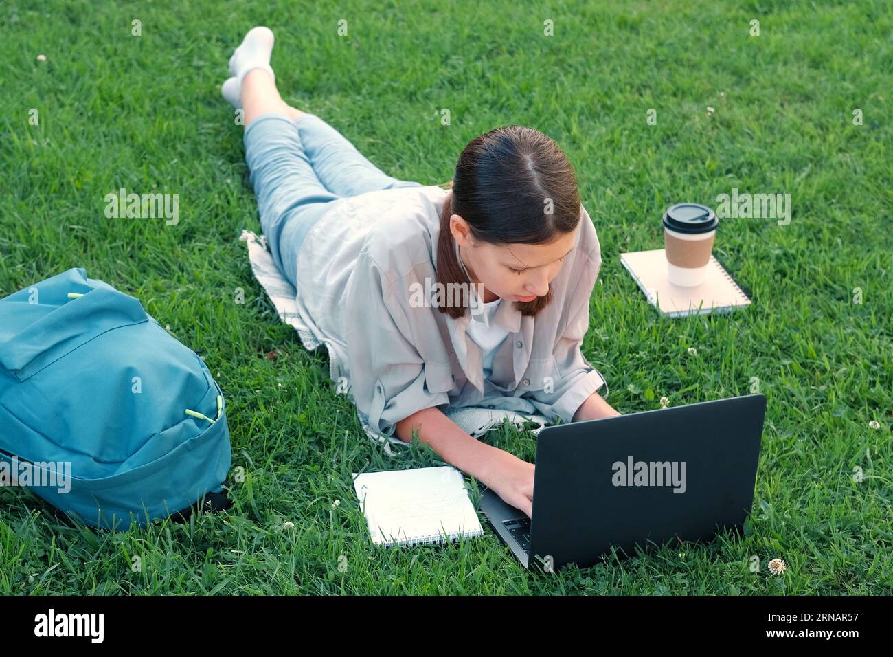 Teenage schoolgirl studying reading her books, tablet and notebook ...