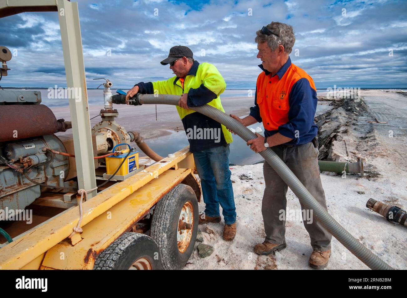 Salt miners pumping water between evaporative ponds at the WA Salt ...