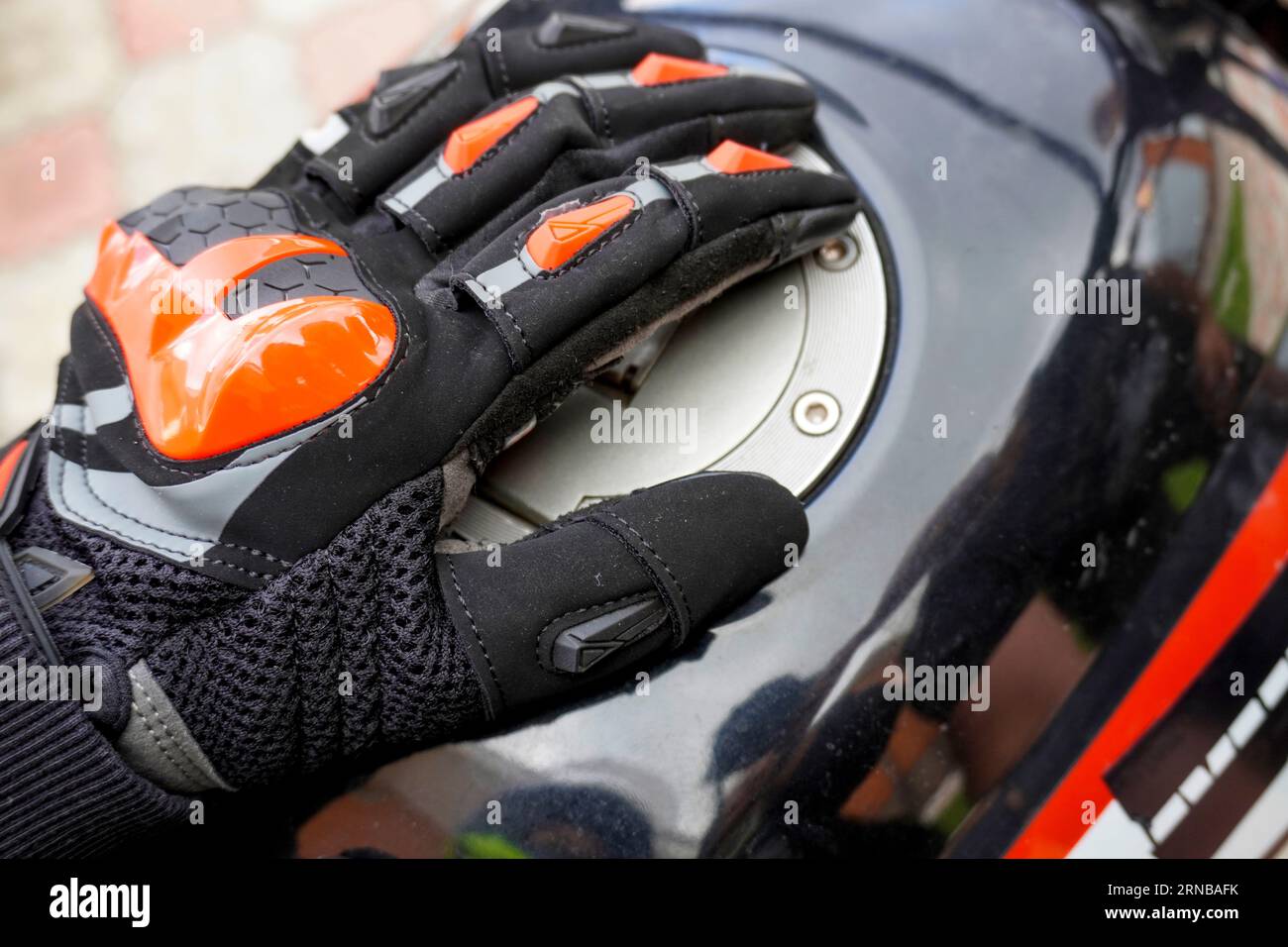 woman motorcyclist in a motorcycle gloves on a motorcycle close-up ...