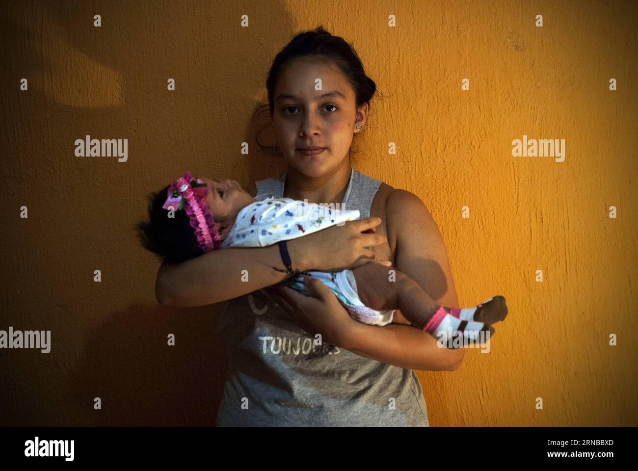 Image taken on Feb. 27, 2016 shows Angela Martinez (Back), holding her daughter Dominic Andrade ...