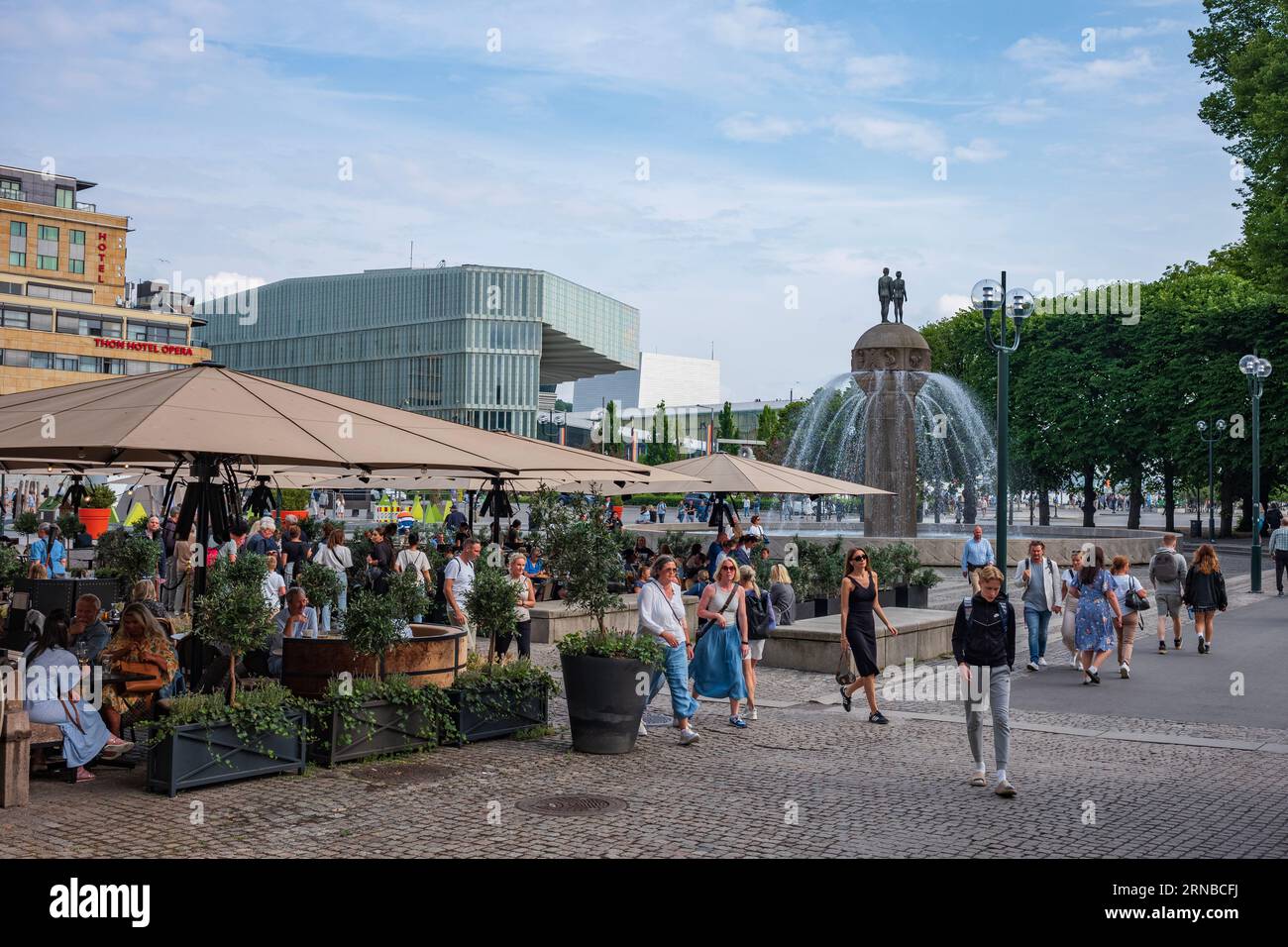 Oslo, Norway - Jun 20, 2023: Crowds of people walk outside in the ...