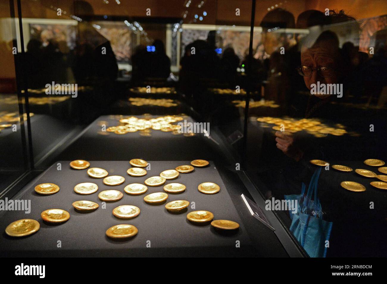 Visitors view gold cakes at an exhibition in Capital Museum in Beijing ...