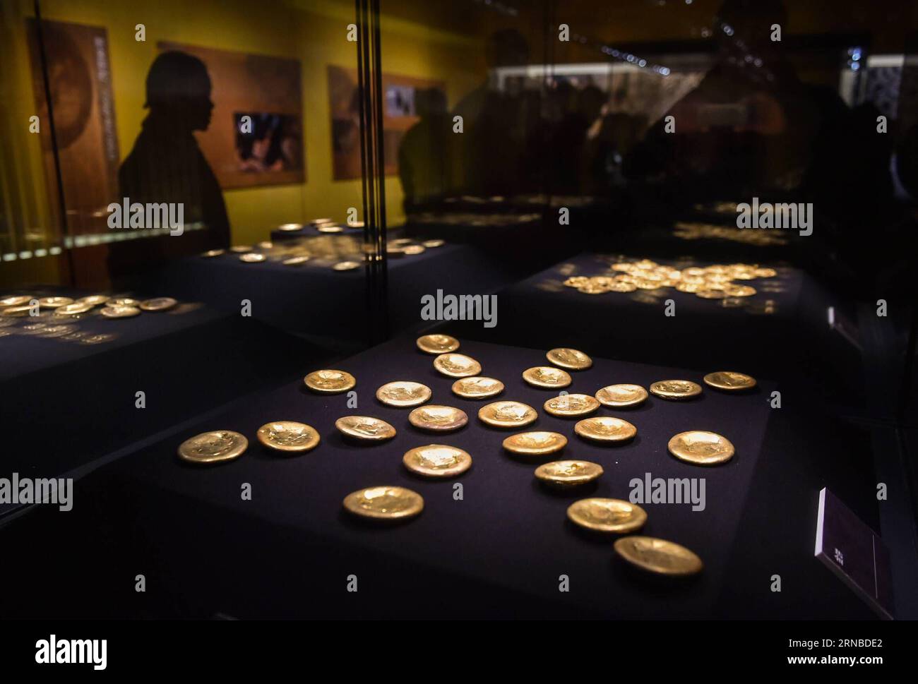 Visitors view gold cakes at an exhibition in Capital Museum in Beijing ...