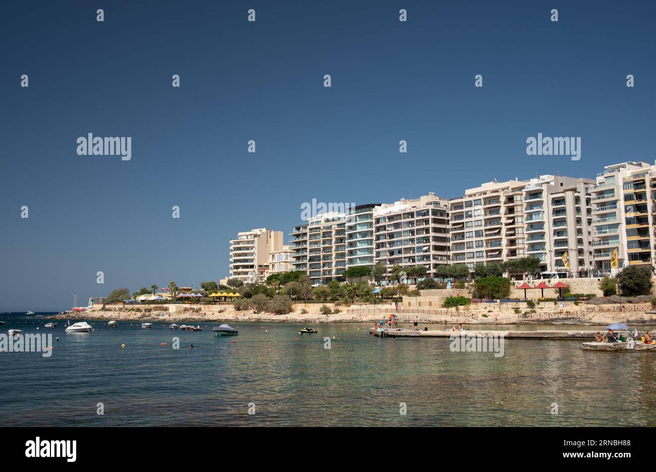Newly built skyscrapers on the coast of Malta are reflected in the sea ...