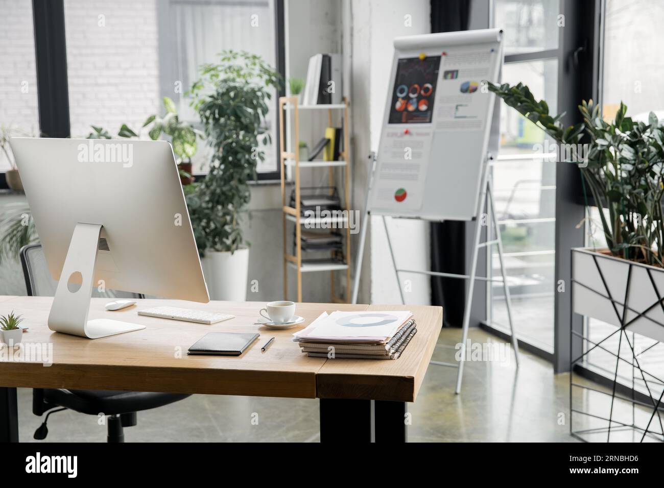 modern office, flip chart, graphs, work desk, computer monitor ...