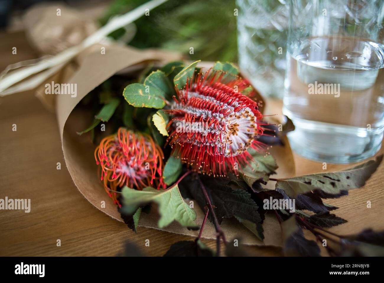 Protea flower stems on table during bouquet assembly Stock Photo - Alamy