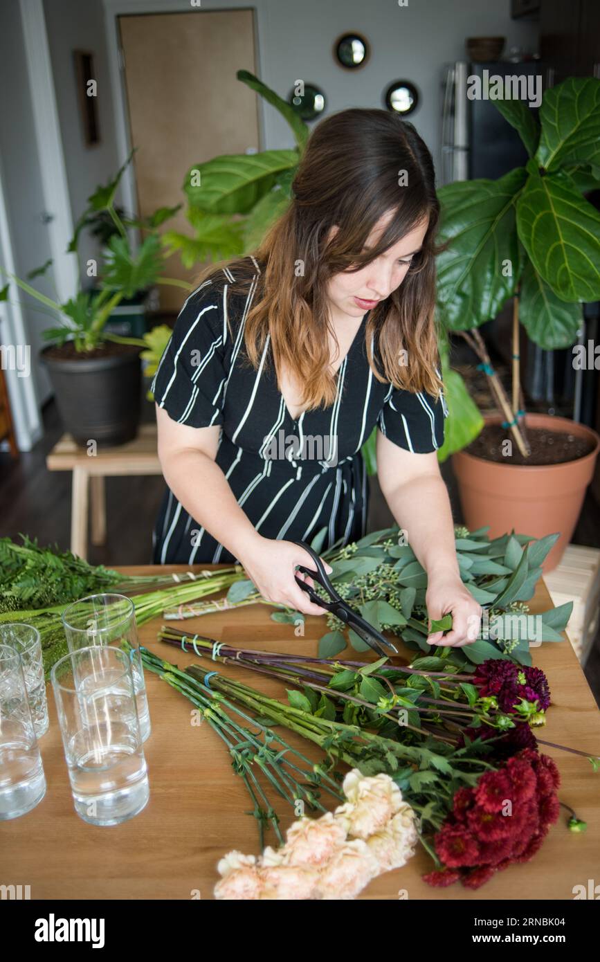 Woman pruning flower stems for bouquet Stock Photo - Alamy