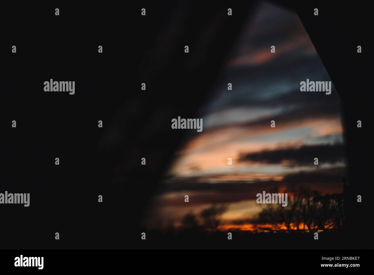 Dreamy sunset view from window with curtain pulled back Stock Photo - Alamy