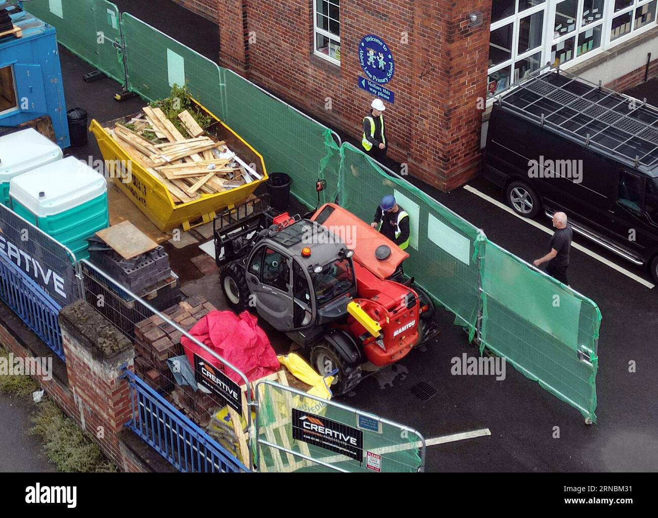 Workmen at Abbey Lane Primary School in Sheffield, which has been ...