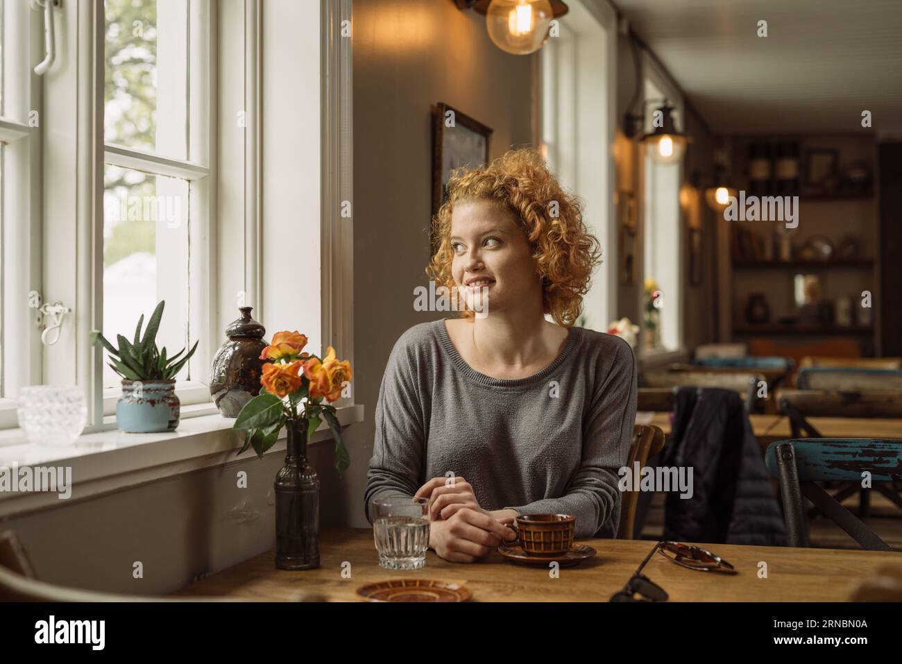 Satisfied female sitting table hi-res stock photography and images - Alamy