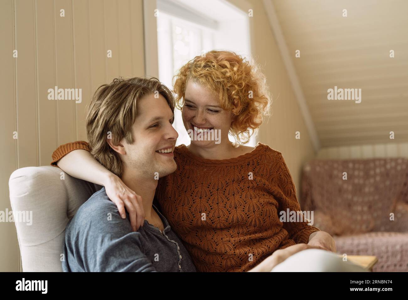 Young couple hugging chair hi-res stock photography and images - Alamy