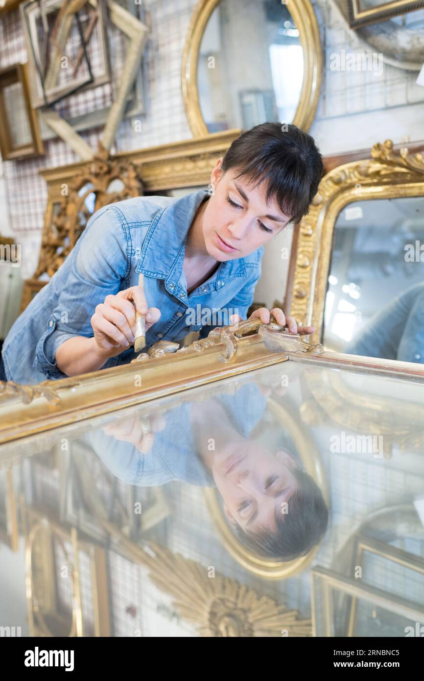 woman restoring an antique frame Stock Photo - Alamy