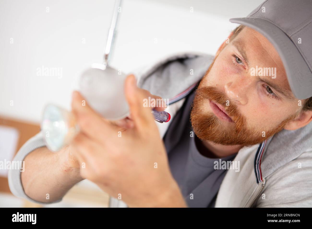 Hand changing light bulb close hi-res stock photography and images - Alamy