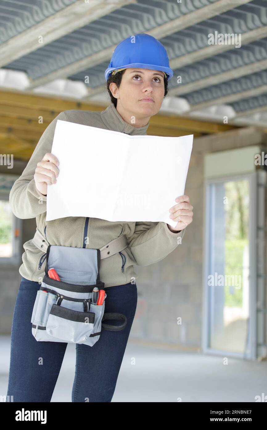 female builder with plan execution Stock Photo - Alamy