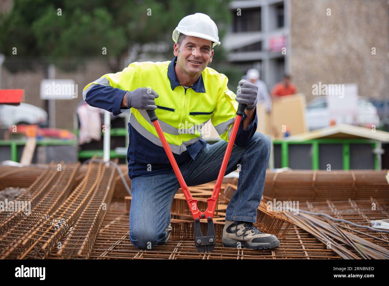 man cutting steel bars outside in construction project Stock Photo - Alamy