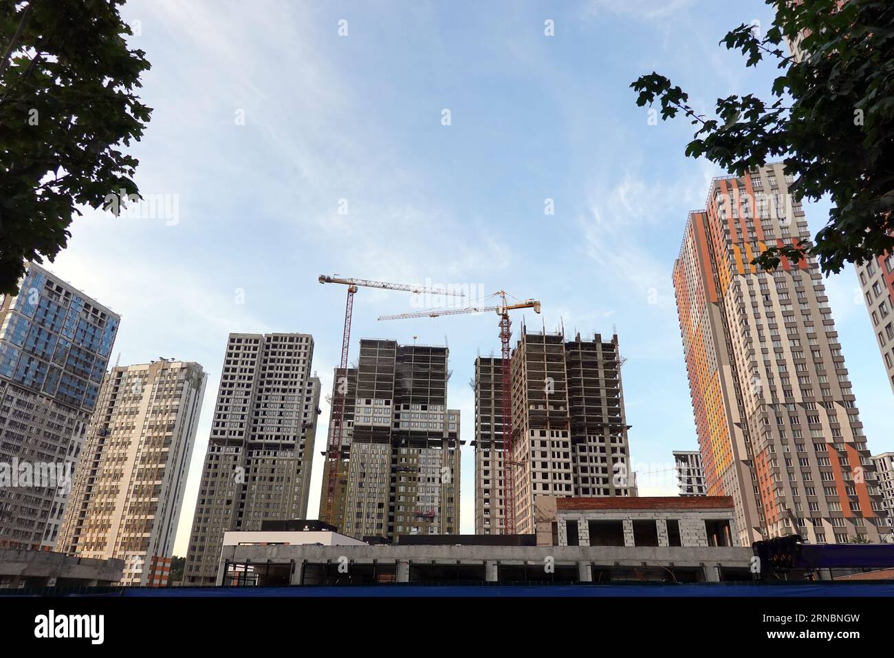 Front view of many being constructed high modern residential buildings ...