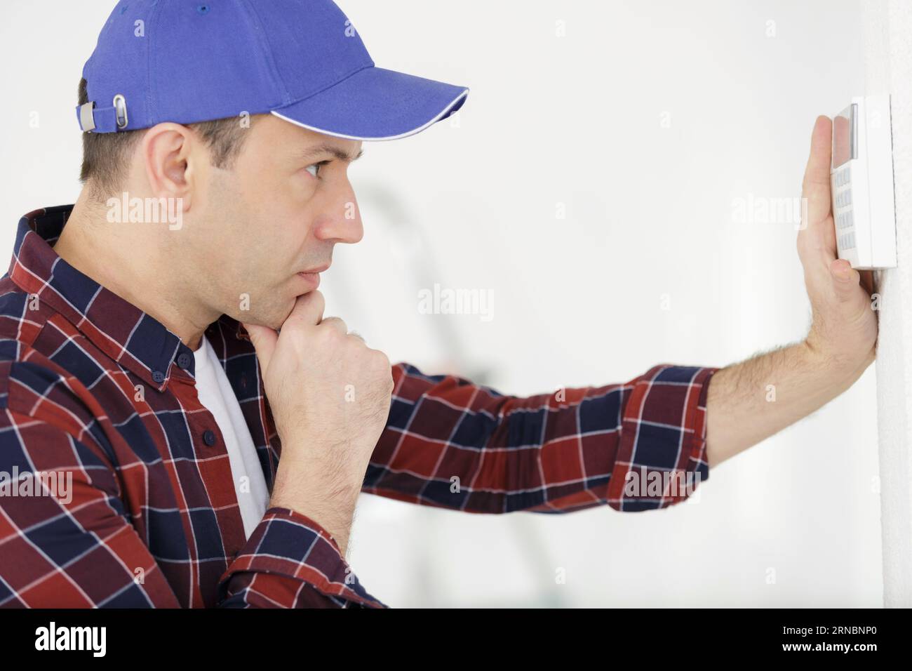 hvac technician installing faceplate on a digital thermostat Stock ...