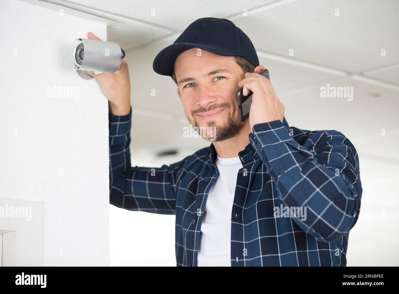 worker is ready to install the cctv camera Stock Photo - Alamy