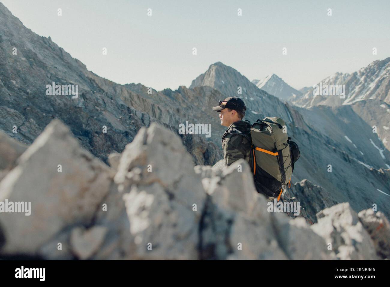 A white male hiker looks forward between mountain ridges Stock Photo ...