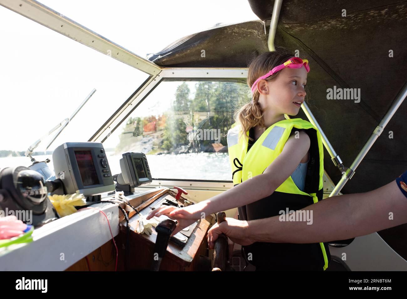 Kid girl driving boat hi-res stock photography and images - Alamy