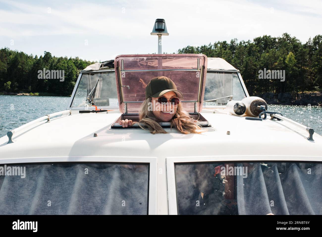 woman smiling looking out of a window on a boat in the sea Stock Photo ...