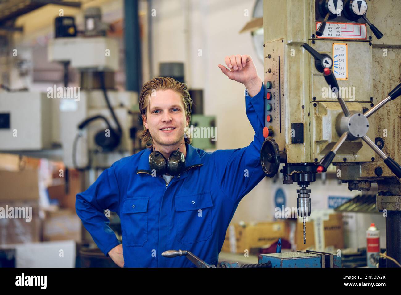 Professional worker standing near drilling machine Stock Photo - Alamy