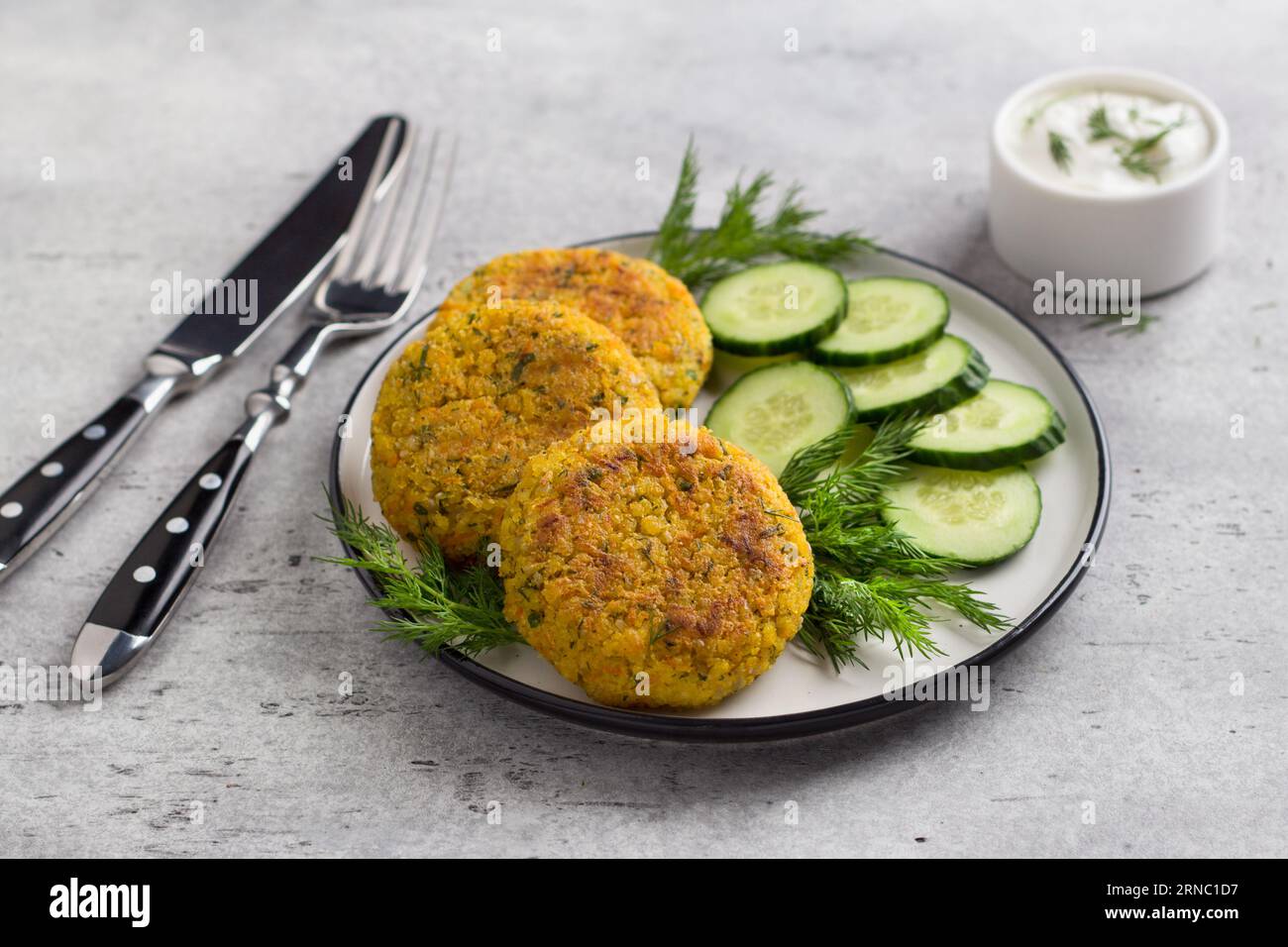 Delicious millet cutlets with carrots and seeds served with cucumber ...