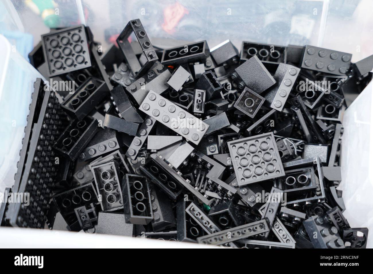 A collection of black building blocks legos on an acrylic box Stock ...