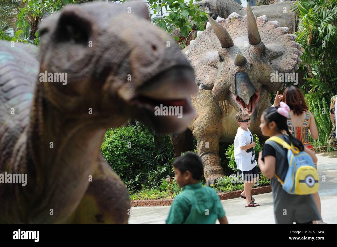 (160325) -- BANGKOK, March 25 -- Visitors look at dinosaur models at ...