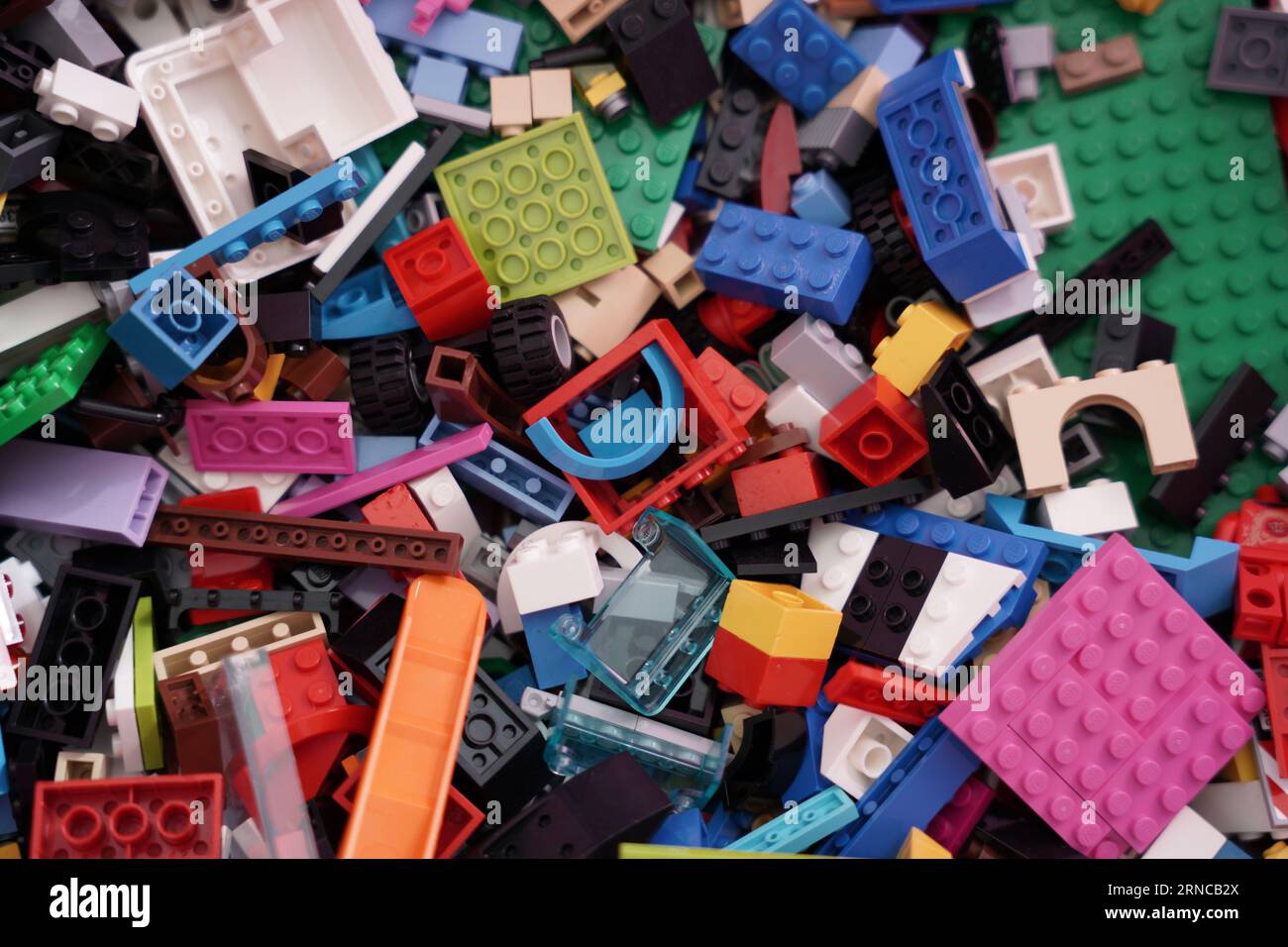 random pieces of legos on a box Stock Photo - Alamy