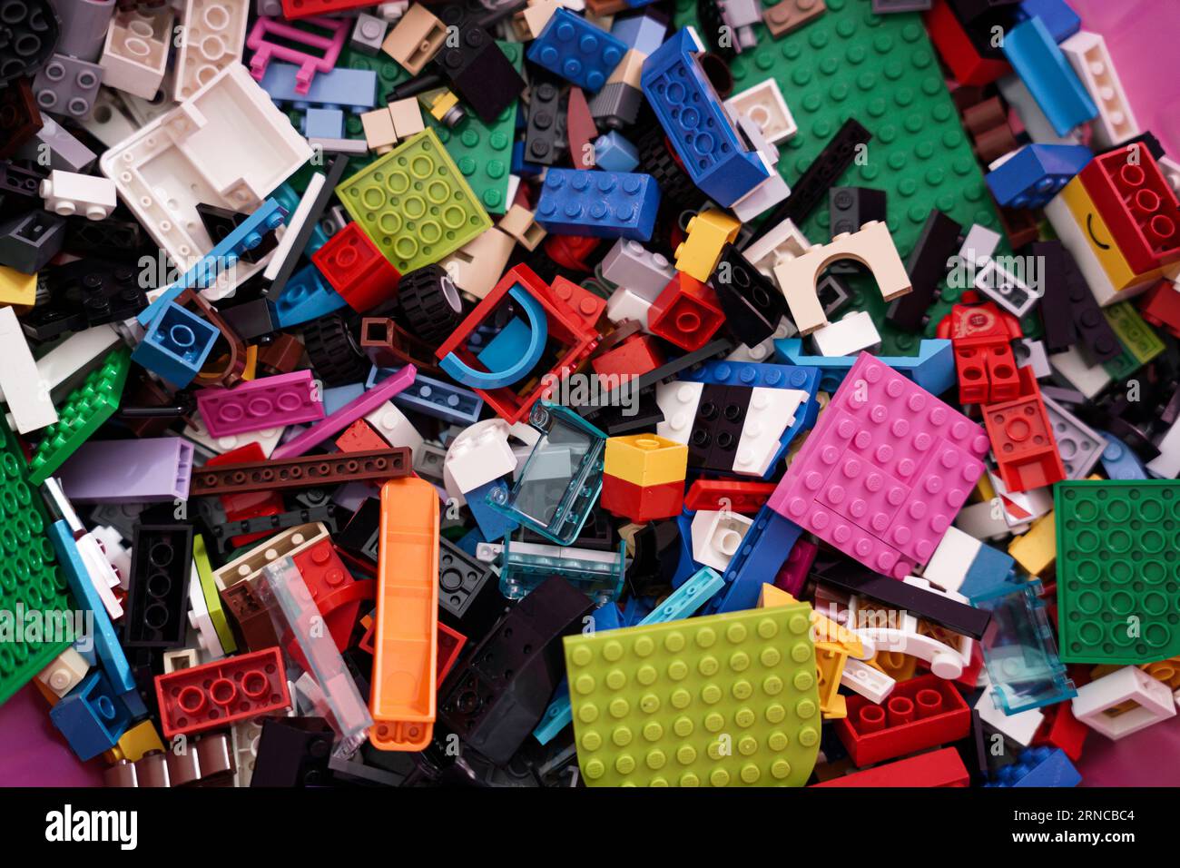 random pieces of legos on a box Stock Photo - Alamy