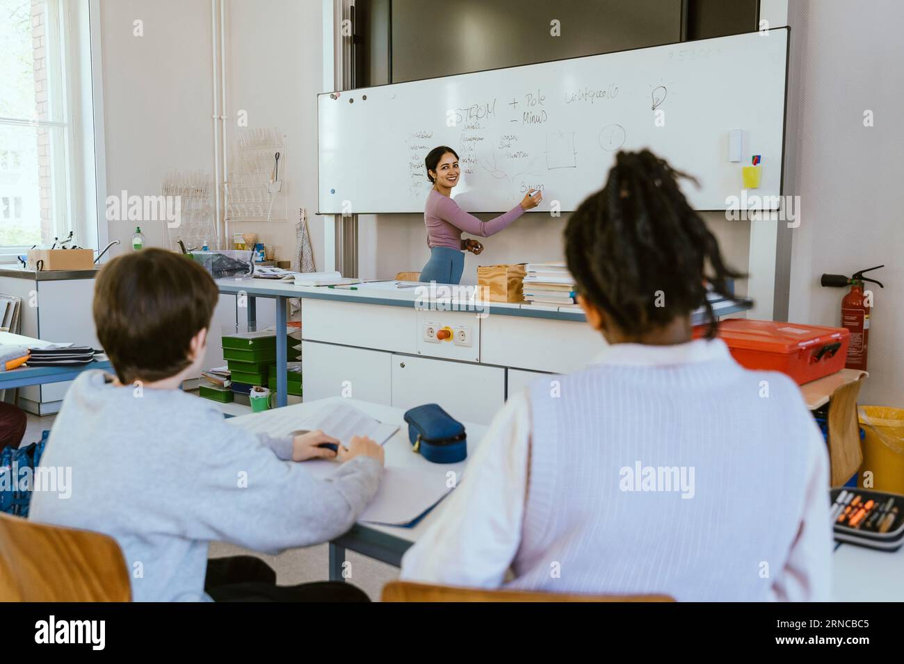 Teacher Writing On Whiteboard
