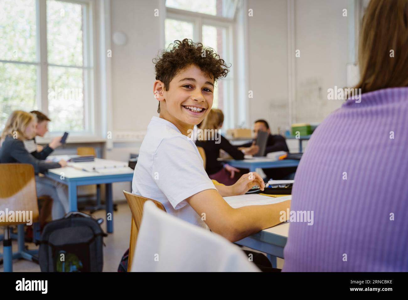 Smiling schoolboy in classroom hi-res stock photography and images - Alamy