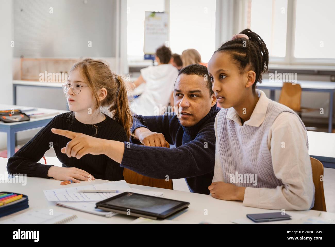 Female teacher helping pensive hi-res stock photography and images - Alamy