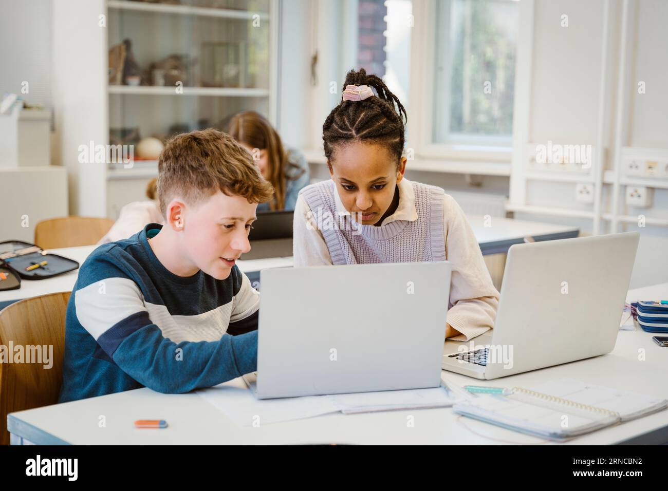 Girls sharing laptop classroom hi-res stock photography and images - Alamy