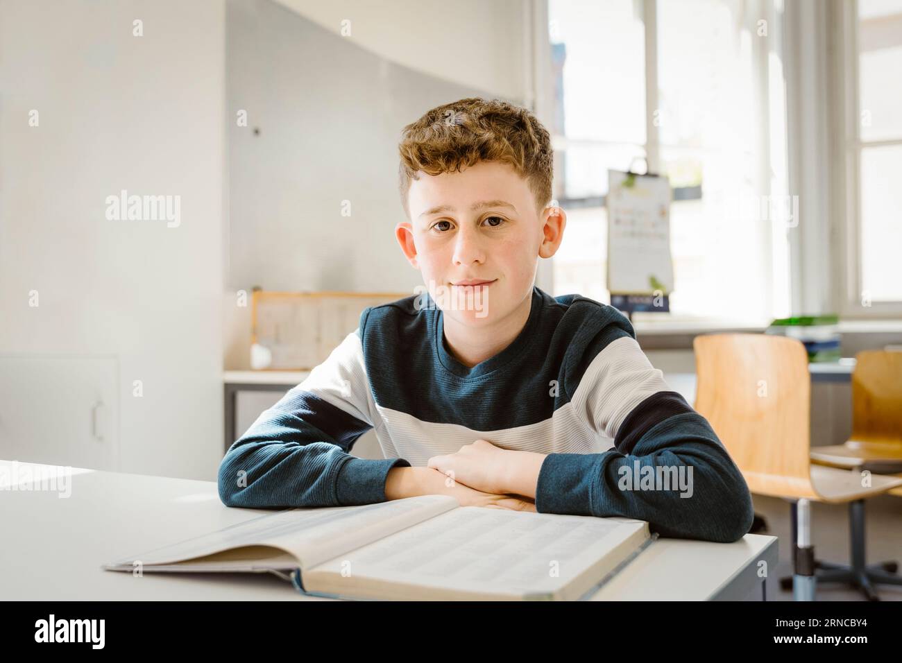 Blond schoolboy in classroom hi-res stock photography and images - Alamy