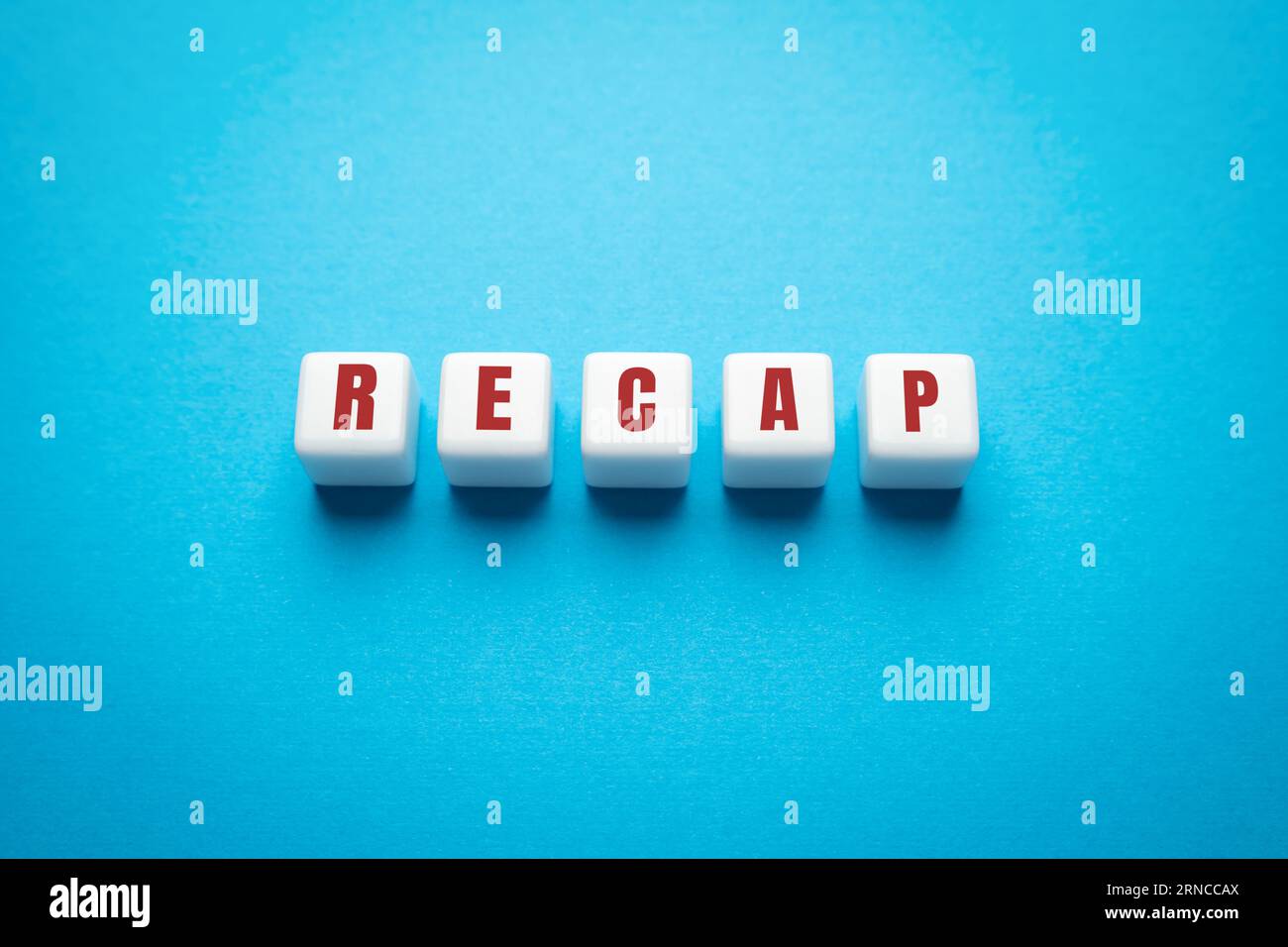 Wooden blocks with the word Recap. A document presenting your skills ...