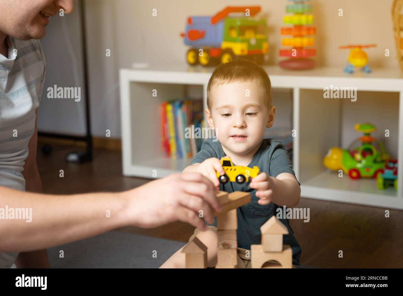 Little toddler boy 2.5 years playing wooden blocks and toy cars with ...