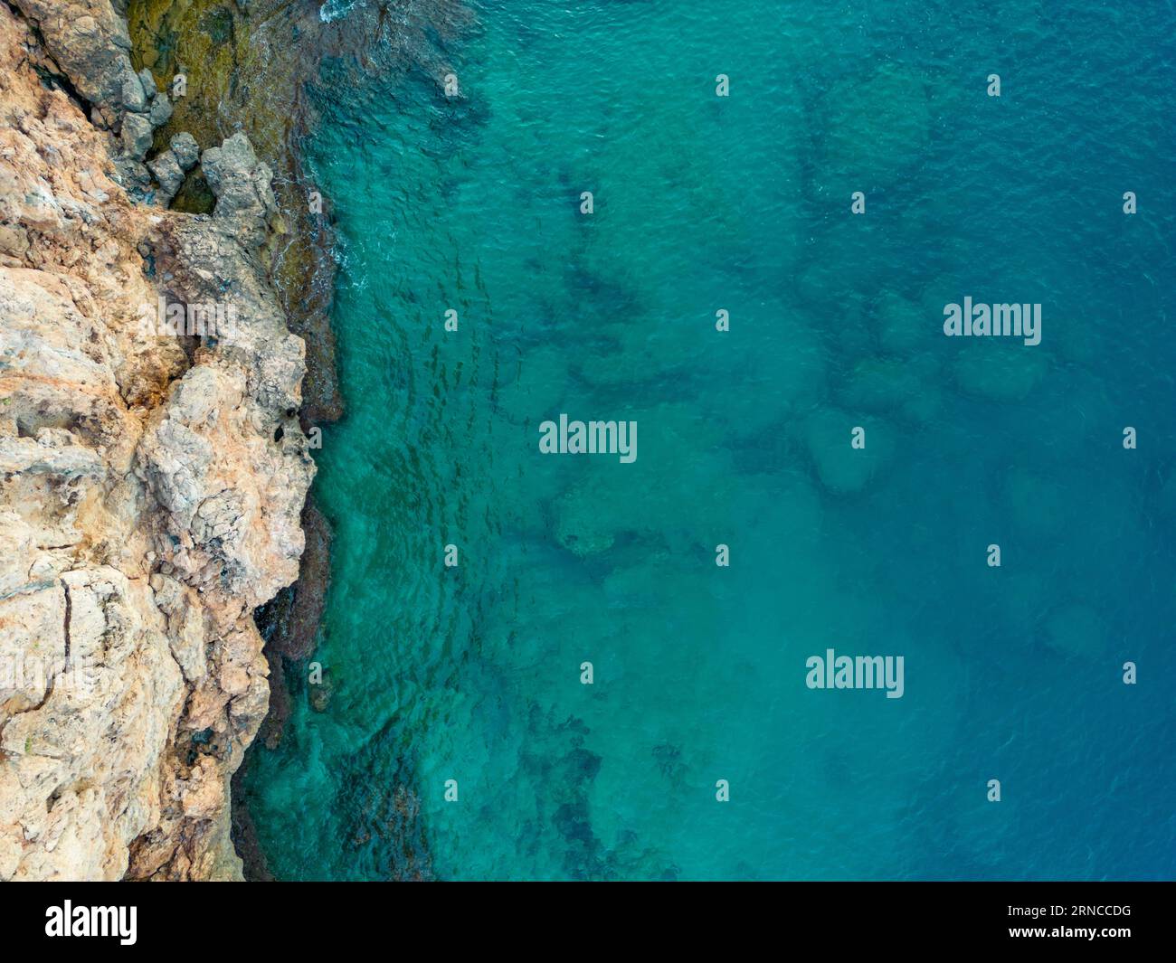 Aerial bird's eye view of cliffs and turquoise sea in Antalya Turkey ...