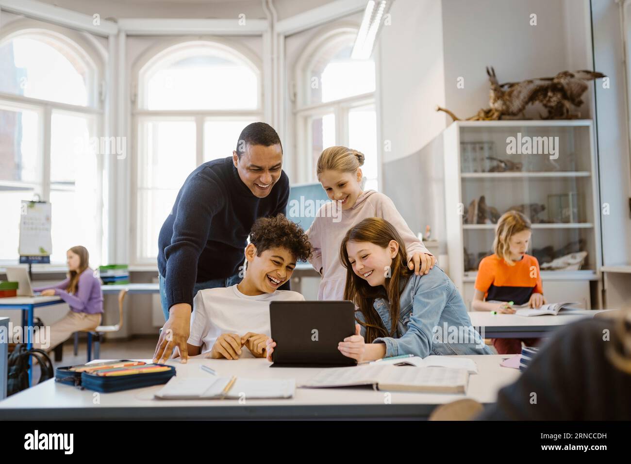 Happy female teacher using hi-res stock photography and images - Alamy