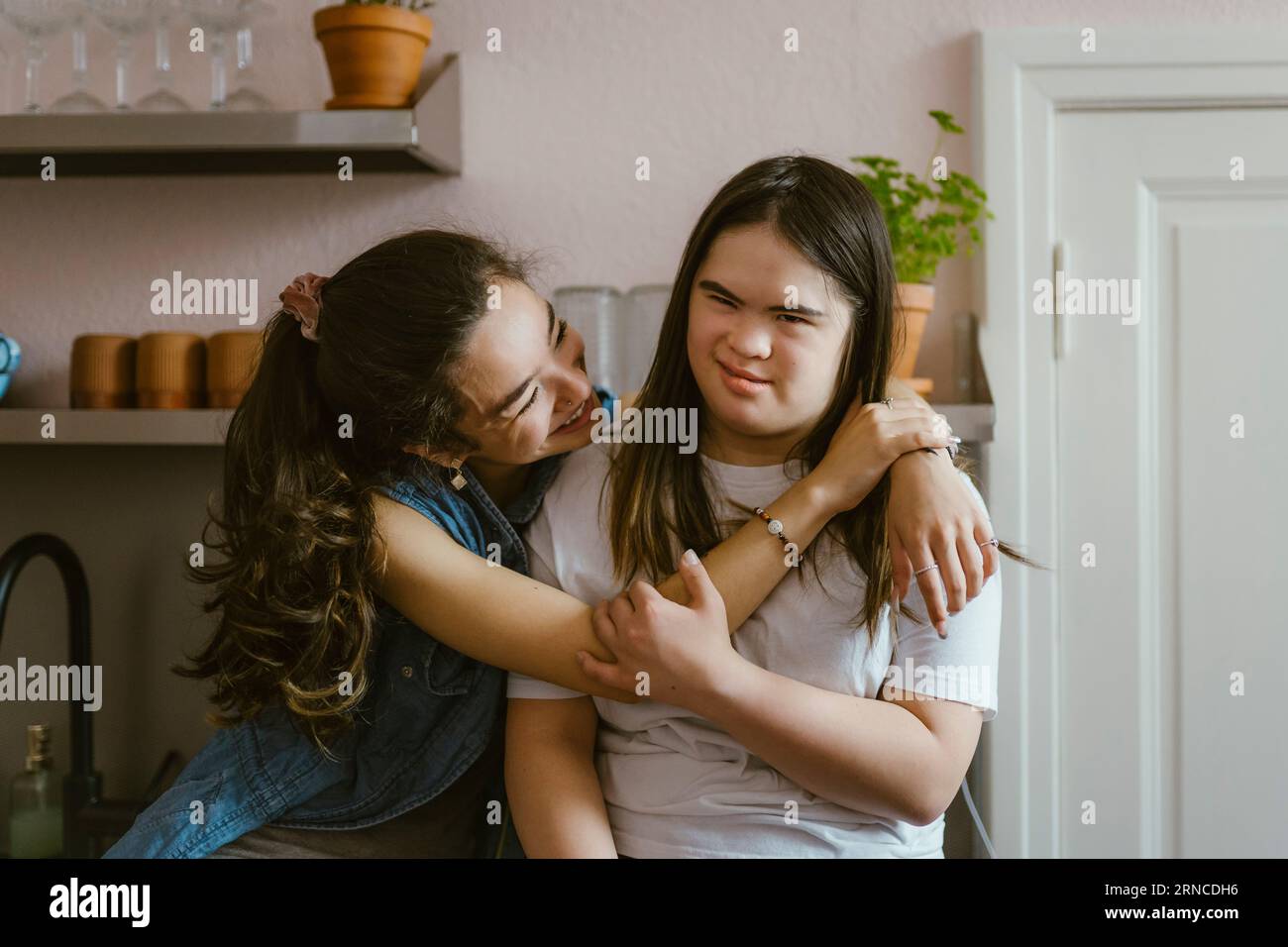 Happy young woman hugging hi-res stock photography and images - Alamy