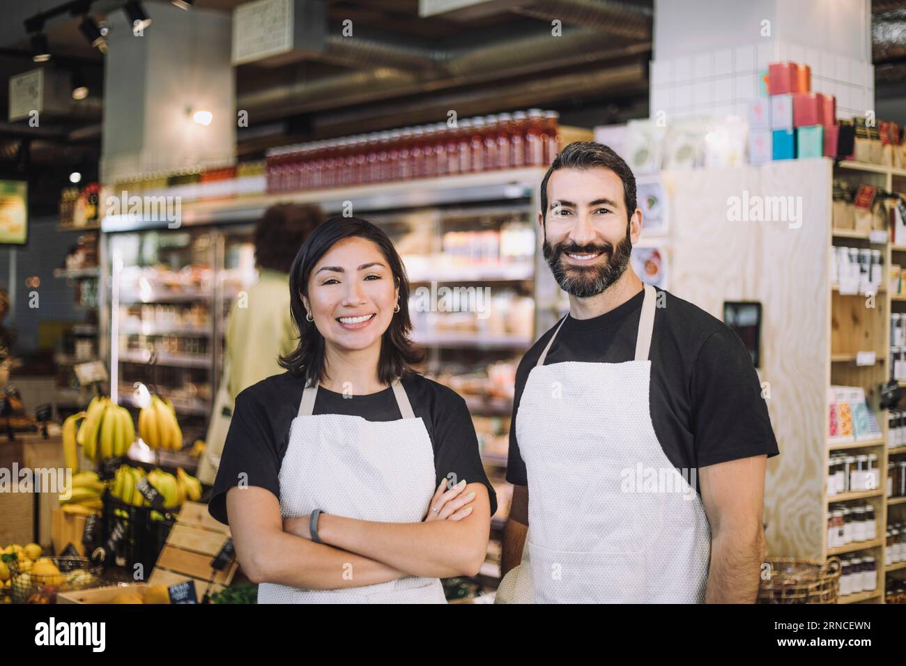 Portrait of smiling multiracial male and female retail clerks wearing ...
